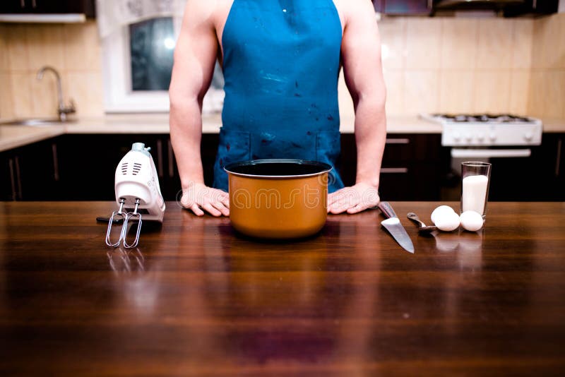 A Young Man is Cooking in a Large Kitchen Stock Image - Image of ...