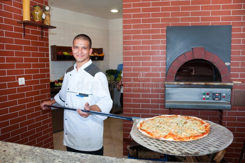 Young man cooking pizza stock image. Image of cooking - 14966805