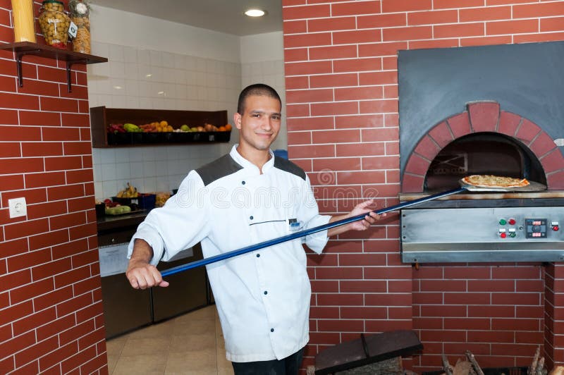 Young man cooking pizza stock image. Image of asian, people - 14966809