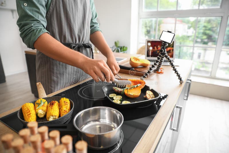Young Man Cooking Vegetables from Video Tutorial in Kitchen Stock Photo ...