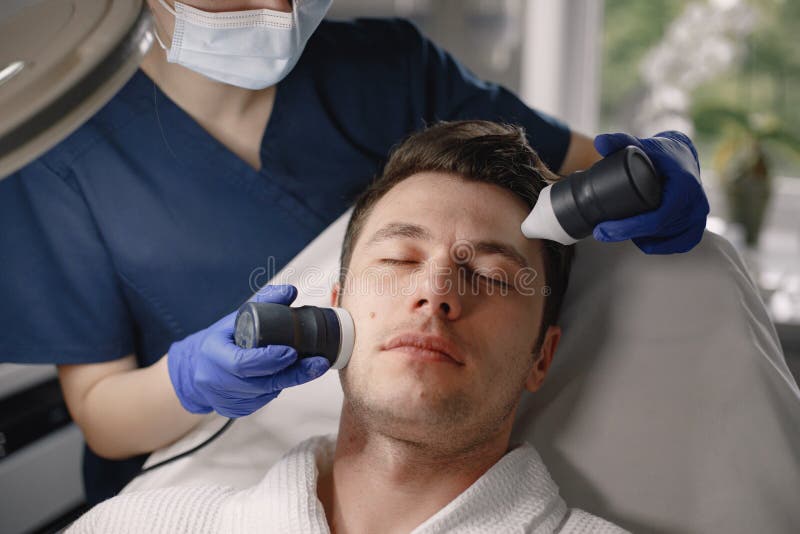 Young Man In Cosmetologist Cabinet Has A Face Procedure Of Cavitation Stock Image Image Of