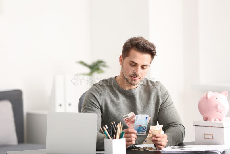Young Man Counting Money at Table Indoors Stock Image - Image of growth ...