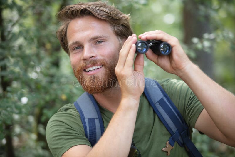 Young Man in Countryside with Backpack and Binoculars Stock Photo ...
