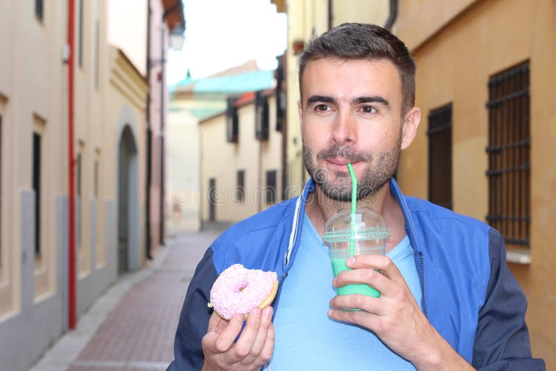 Young man craving a donut stock image. Image of high - 164469111