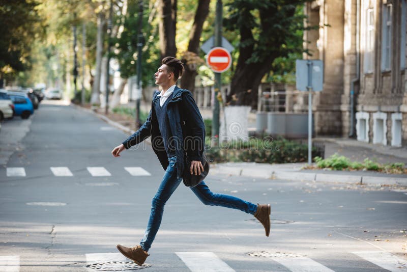 Young man cross the street stock photo. Image of europe - 46805520