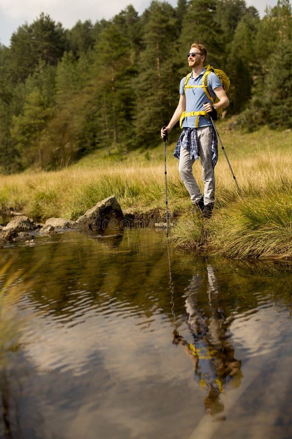 Young Man Crosses a Mountain Stream on a Sunny Day Stock Photo - Image ...