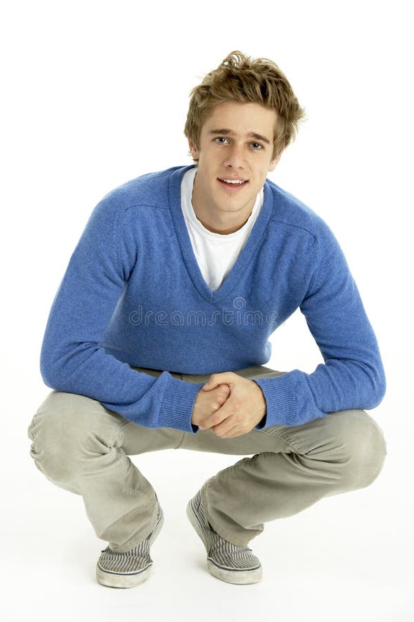 Young Man Crouching in Studio Stock Image - Image of person, style ...