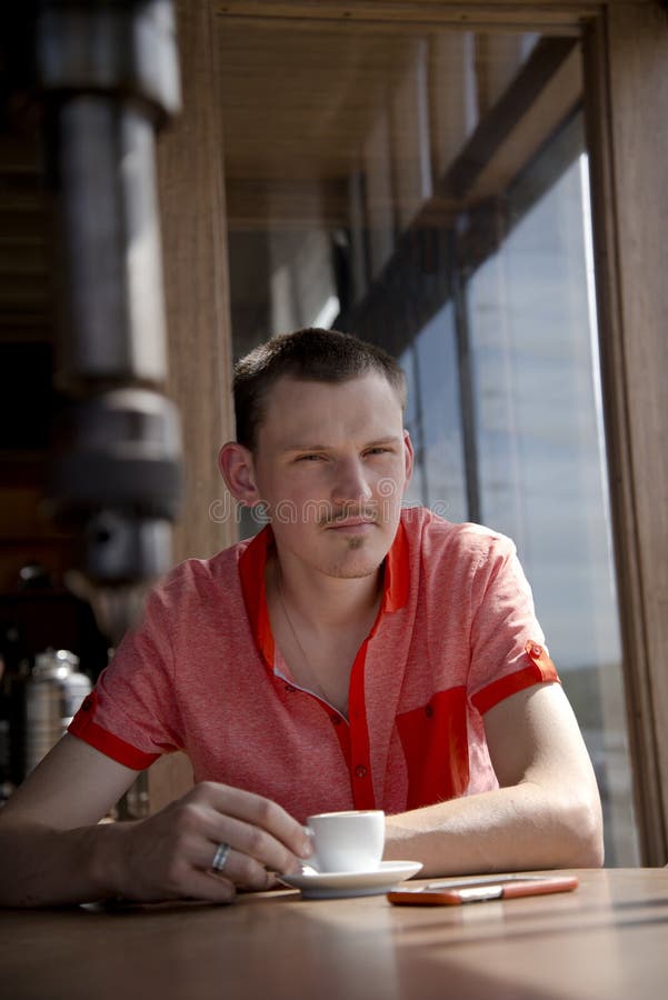 Young Man with Cup of Coffee Sitting Near the Window Stock Image ... Young Man with Cup of Coffee Sitting Near the Window Stock Image ...