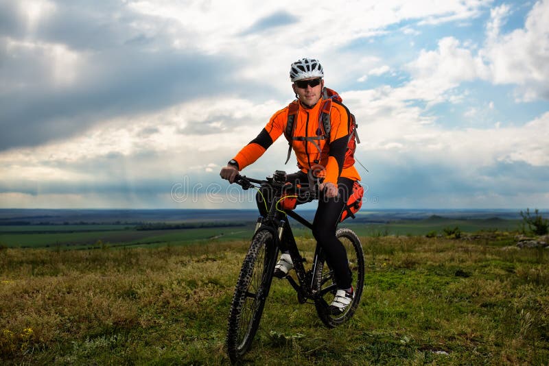 Young Man Cycling on a Rural Road through Green Meadow Stock Image ...