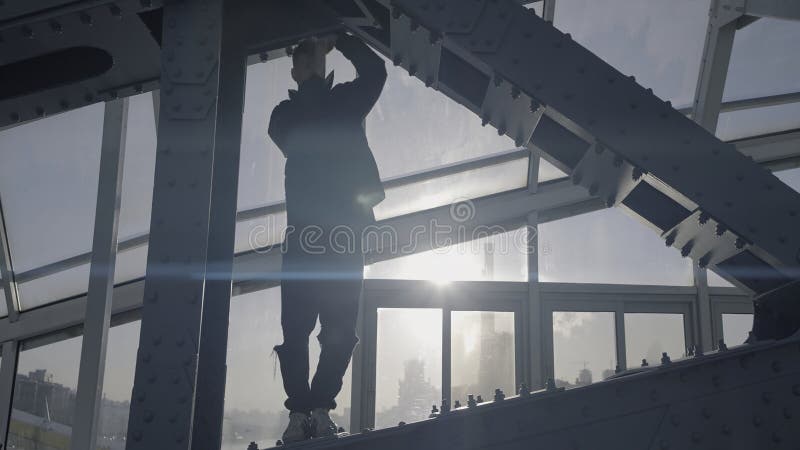 Young Man Dances on Bridge on Background of Sun. Action. Young Man is ...