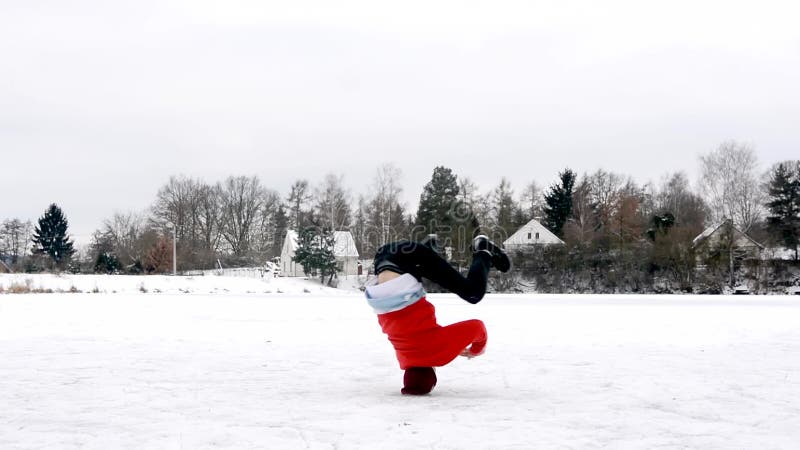 Young Man Dancing Breakdance on a Frozen Pond in Winter. Stock Footage ...