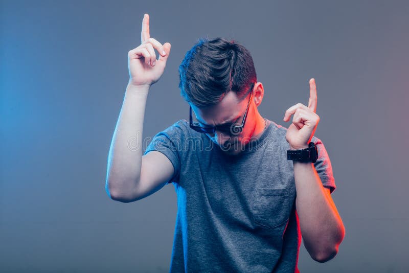 Young Man Dancing and Pointing Fingers Up Stock Photo - Image of action ...