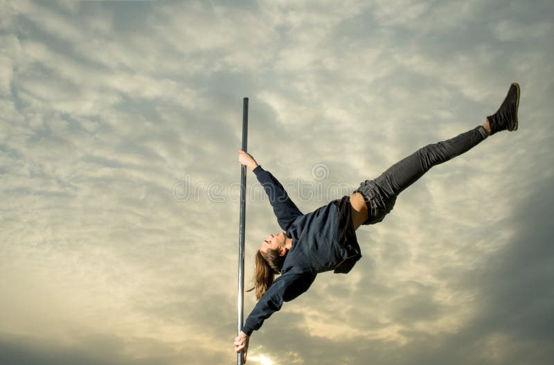 Strong Dancer Workout on Pole. Freedom. Pole Dance Sport. Athletic Man ...