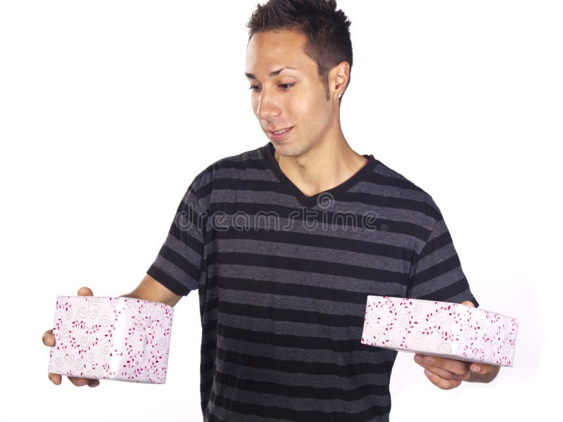 Young Man Deciding on Which Gift To Open First Stock Image - Image of ...