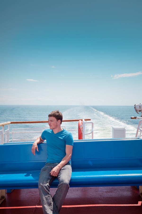The Young Man on the Deck Against the Sea Stock Image - Image of blue ...