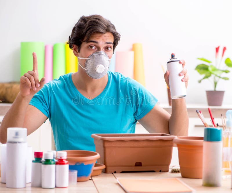 Young Man Decorating Pottery in Class Stock Image - Image of mask ...