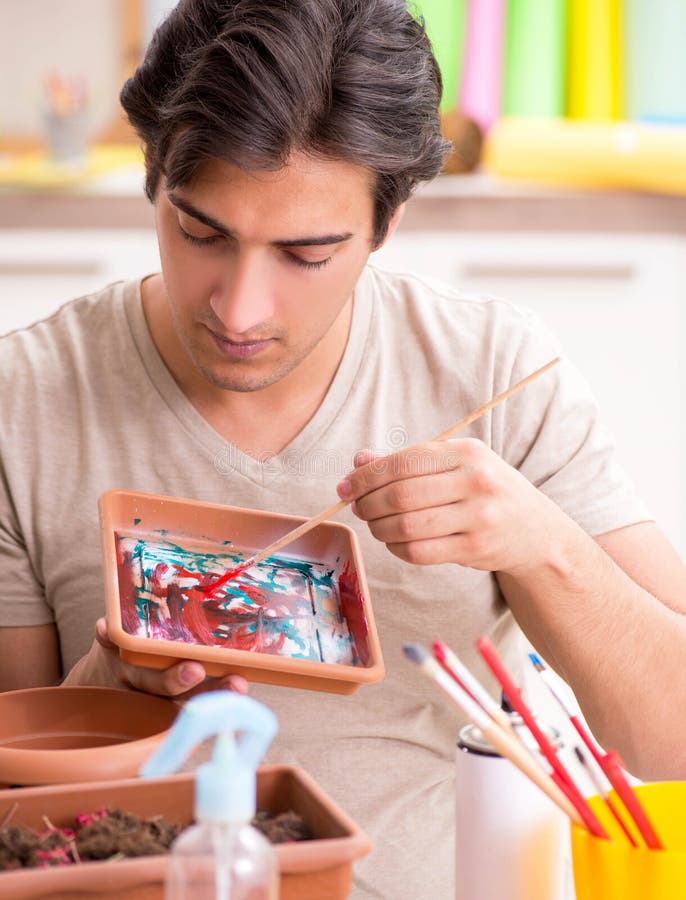 Young Man Decorating Pottery in Class Stock Image - Image of ...