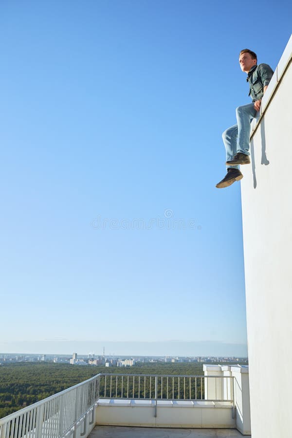Young Man in Denim Clothes Sits on Edge of the Stock Image - Image of ...