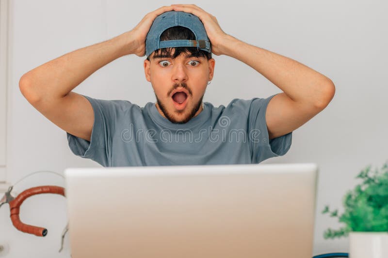 Young Man at Desk Shocked Looking at Computer Stock Image - Image of ...