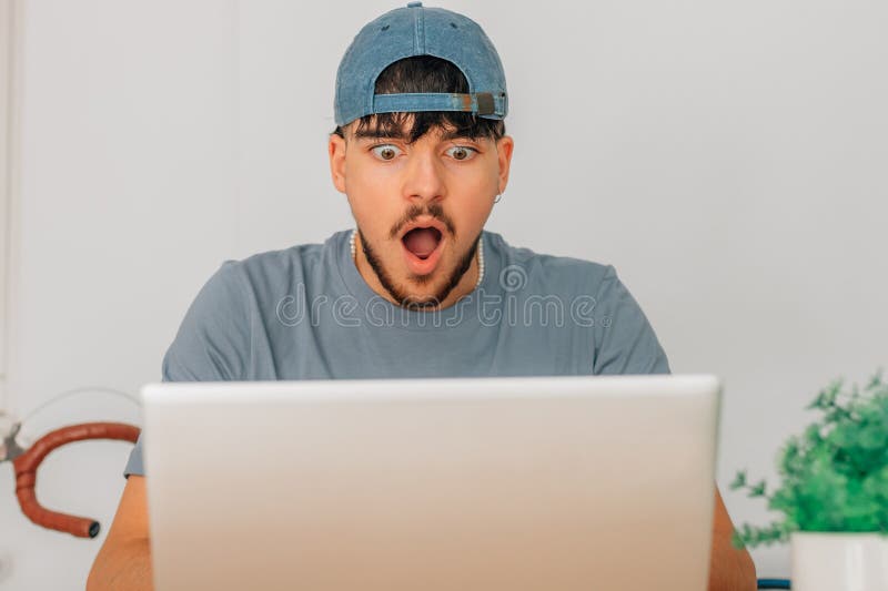 Young Man at Desk Shocked Looking at Computer Stock Photo - Image of ...