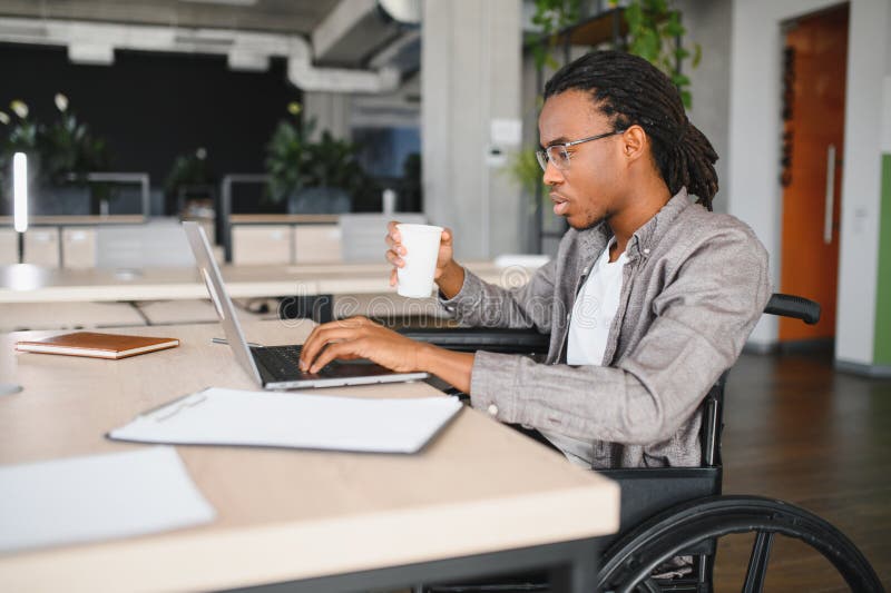 Focused African American Employee with Disability Working on Laptop in ...
