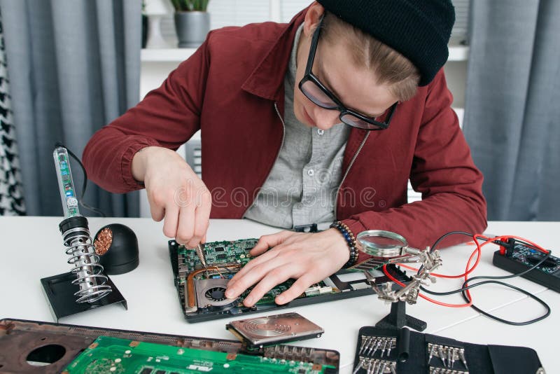 Young Man Disassembling Computer Motherboard. Stock Photo - Image of ...