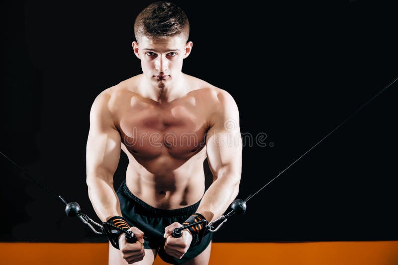 Young Man Does Hand-cutting on the Simulator in the Gym. Exercise for ...
