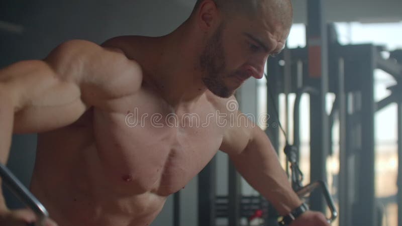 Young Man Does Hand-cutting on the Simulator in the Gym. Exercise for ...