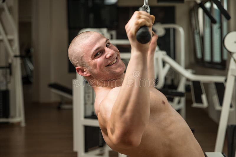 Young Man Doing Back Exercise on a Machine Stock Image - Image of back ...