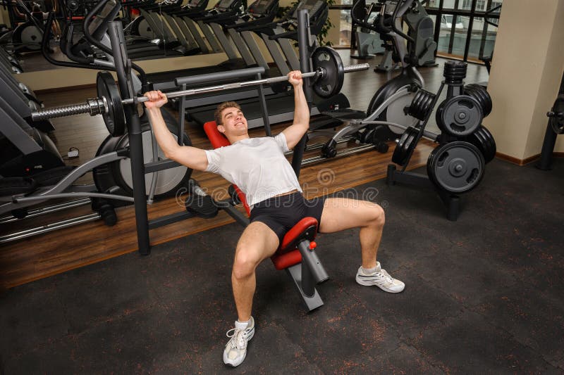 Young Man Doing Barbell Incline Bench Press Workout in Gym Stock Image ...