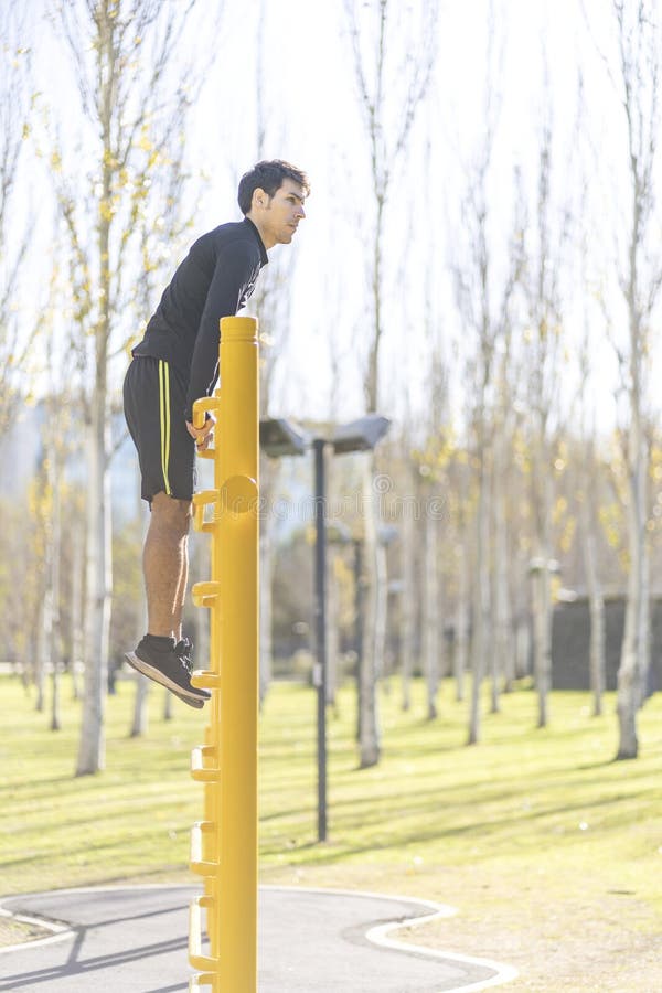Man Doing Climbing Vertical Exercise in the Park Stock Photo - Image of ...