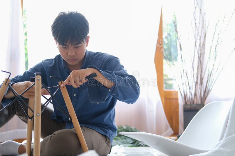 Young Man Doing DIY Work, Assembling Furniture at Home. Stock Photo ...