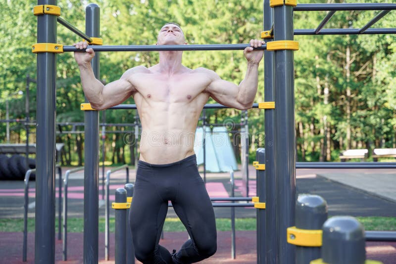 Young Man Doing Exercise on a Horizontal Bar Outdoors Stock Photo ...