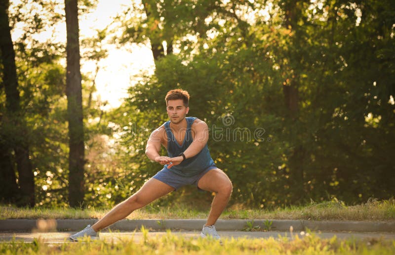 Young Man Doing Exercise in Park Stock Image - Image of green, space ...