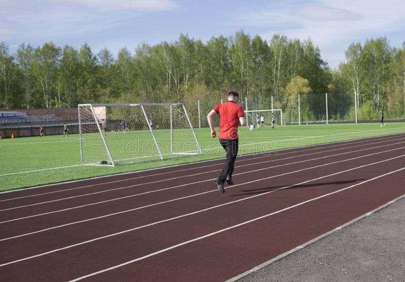Young Man in Doing Exercise. at the Stadium Editorial Image - Image of ...
