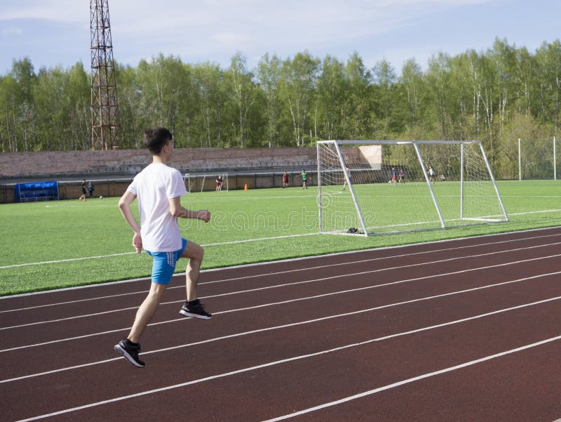 Young Man in Doing Exercise. at the Stadium Editorial Stock Photo ...