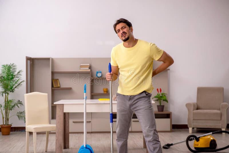 Young Man Doing Housework at Home Stock Photo - Image of backache ...