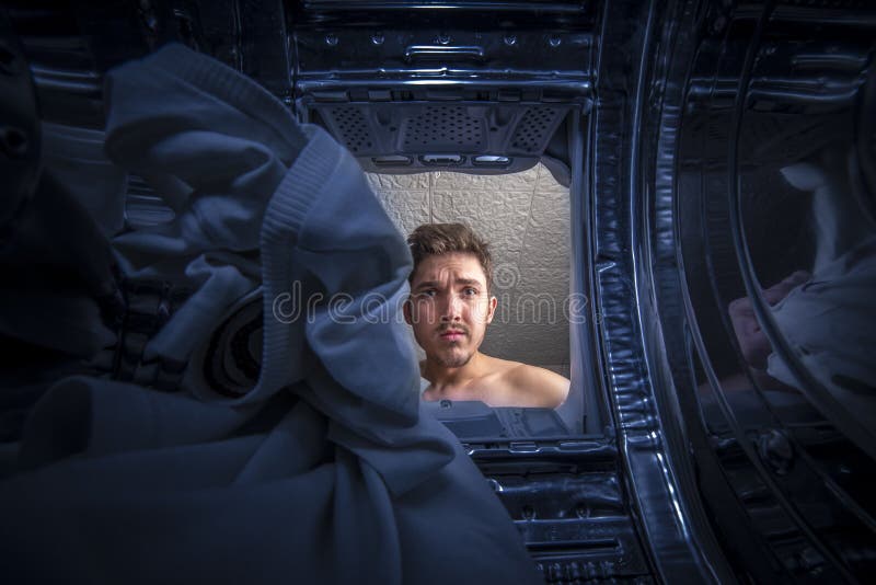 Young Man Doing Laundry View from the Inside of Broken Washing Machine ...