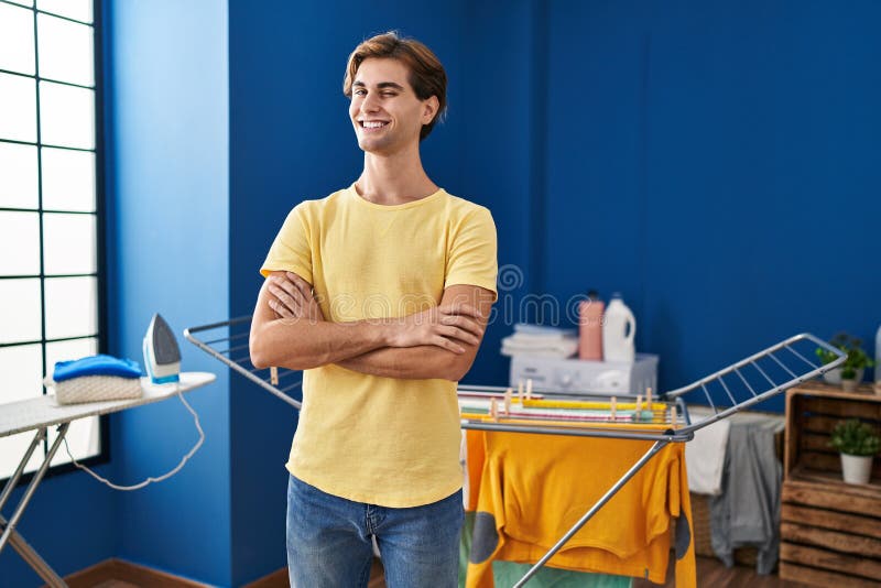 Young Man Doing Laundry Winking Looking at the Camera with Expression ...