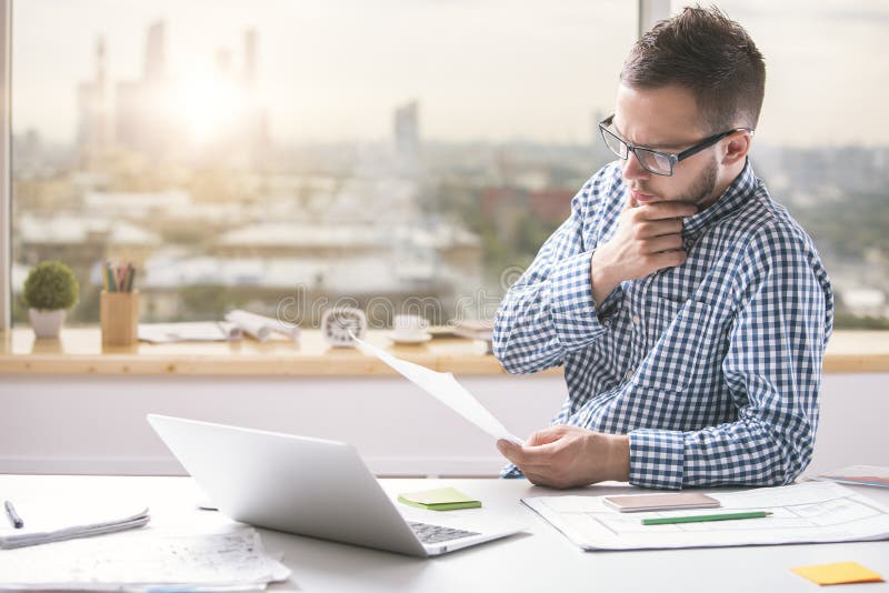 Young man doing paperwork stock photo. Image of items - 78616158