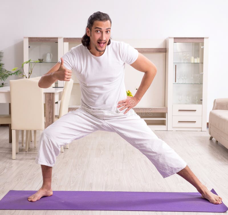 Young Man Doing Physical Exercises at Home Stock Photo - Image of ...
