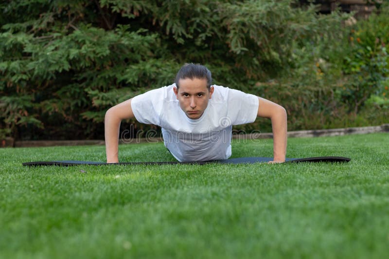 Young Man Doing Push Ups Looking at Camera Having a Healthy Life Style ...