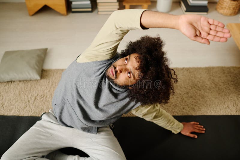 Young Man Doing Side Bends on the Floor Stock Photo - Image of adult ...