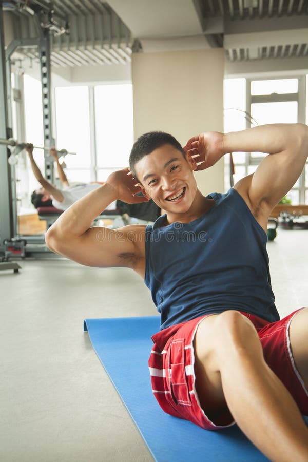 Young Man Doing Sit-ups in the Gym Stock Image - Image of looking ...