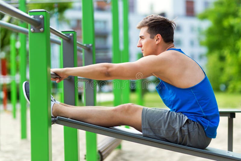 Young Man Doing Sit-ups at Outdoor Gym Stock Photo - Image of fitness ...