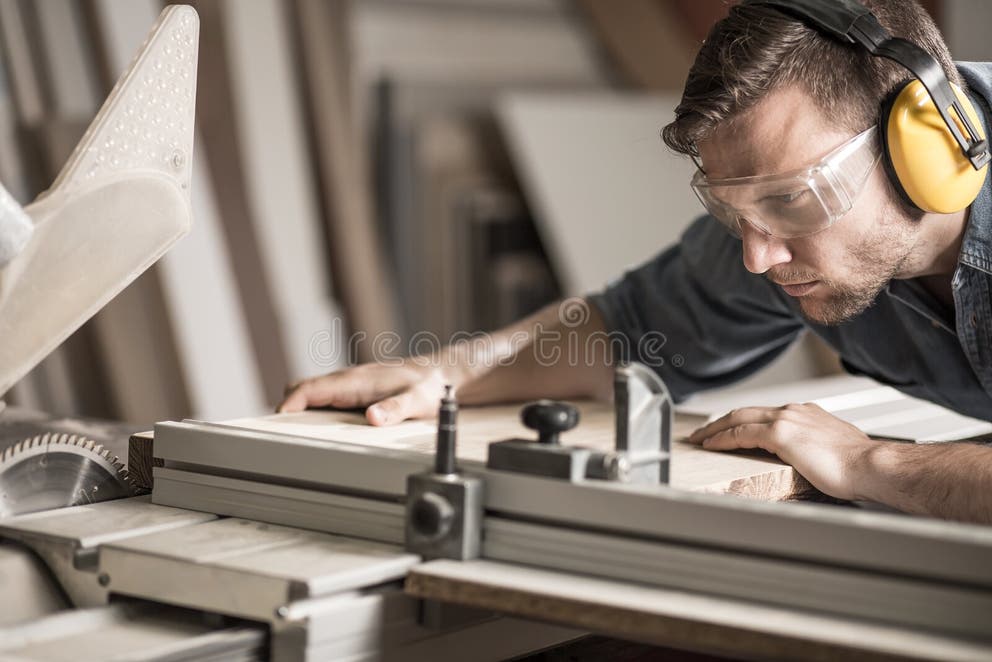 Young man doing woodwork stock image. Image of measurement - 56162691