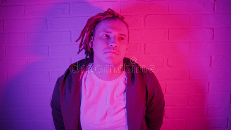 Young Man with Dreadlocks in a Pink Neon Light. Portrait of a Male ...