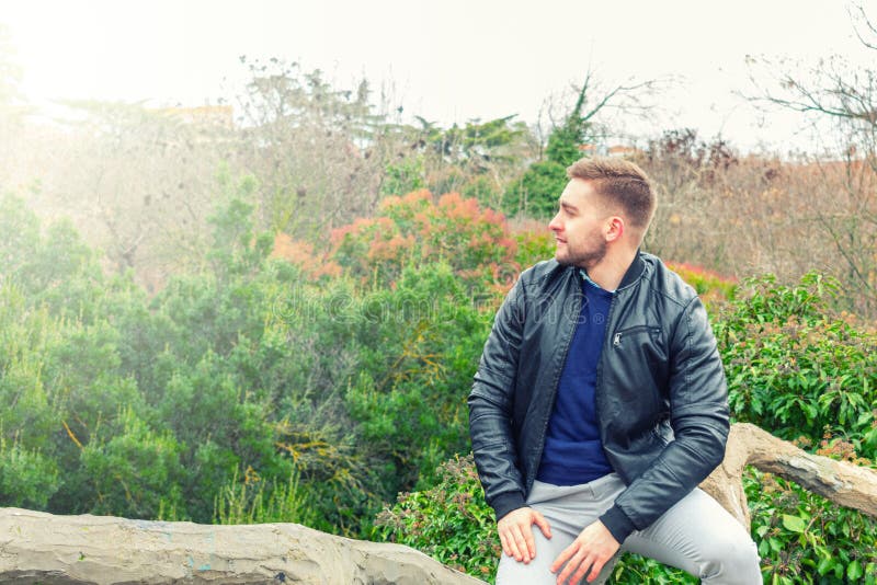 Young Man Dressed in Fashion Looking into Infinity between Trees Stock ...