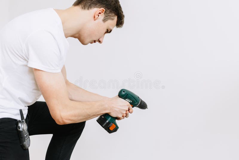 Young Man with the Drill or Screwdriver Isolated on White Background ...