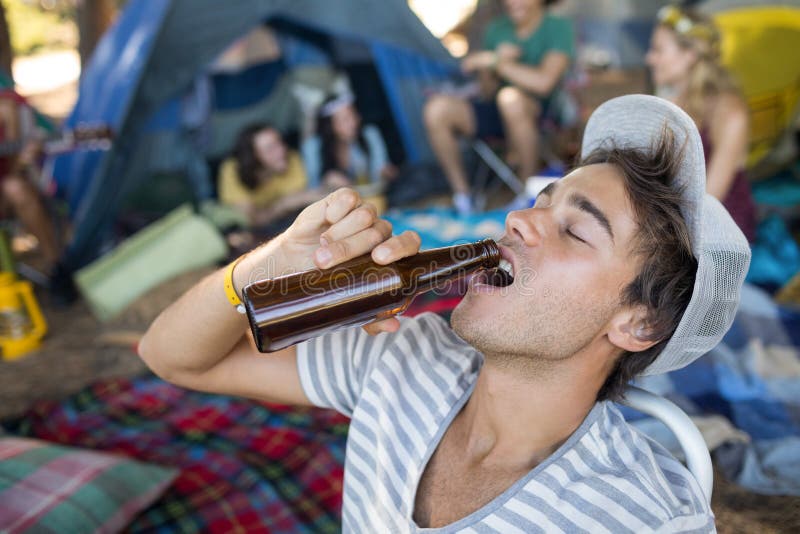 Young Man Drinking Beer from Bottle Stock Image - Image of closed ...